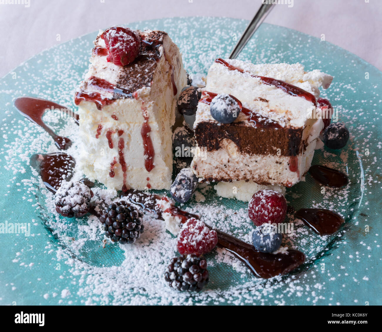 Sweet meringue cake(Pavlova) with fresh winter berry fruits on glass ...