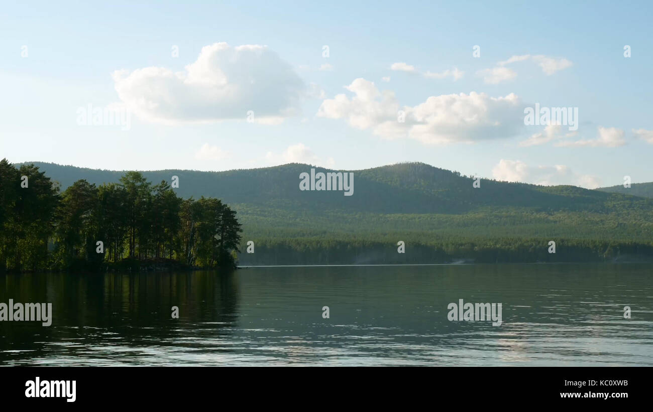 Summer landscape with river, cloudy sky, forest and sun timelapse ...