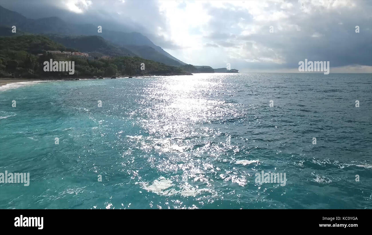 Azure beach with rocky mountains and clear water. Footage. Aerial Stock ...