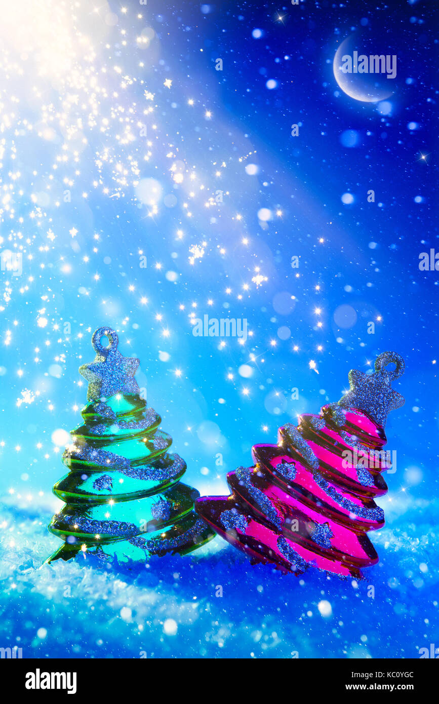 two Christmas tree on blue night background Stock Photo - Alamy