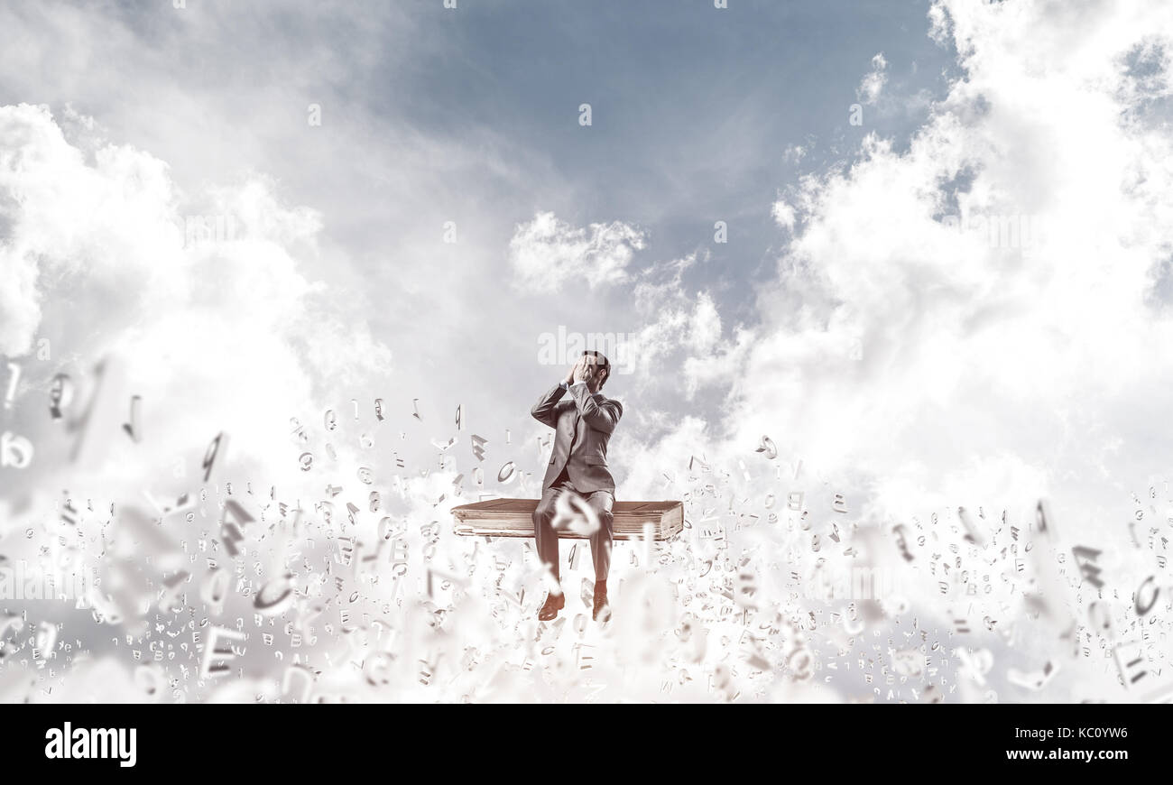 Young man floating in sky and do not want to see anything Stock Photo ...