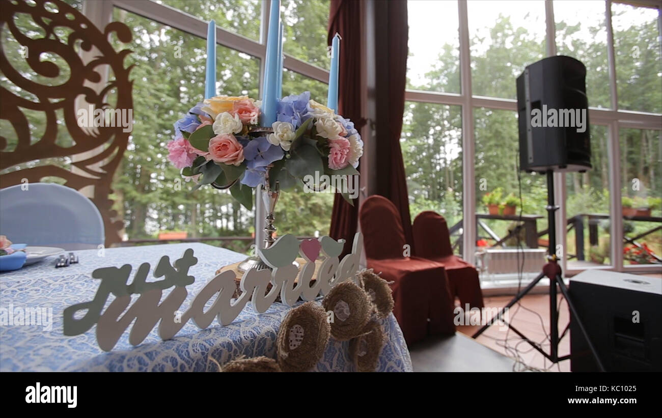 Wedding table at a wedding feast decorated with bridal bouquet. Banquet ...