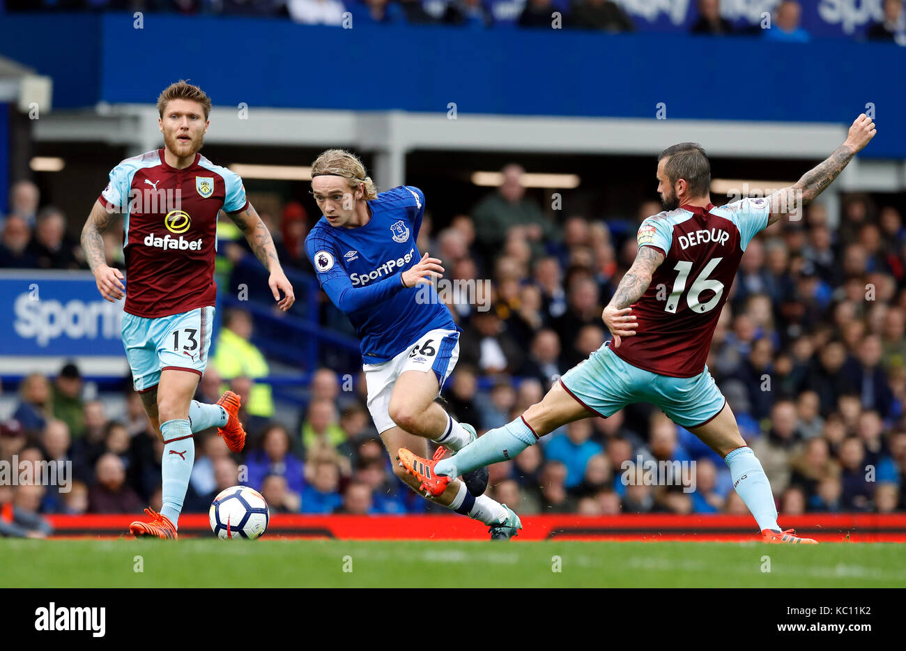 Everton's Tom Davies and Burnley's Steven Defour (right) battle for the ...