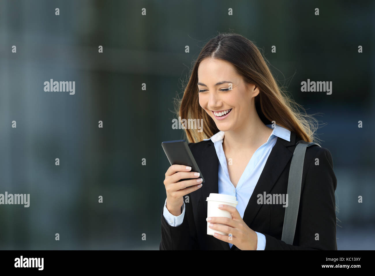 Single executive checking content in a smart phone and holding a take ...