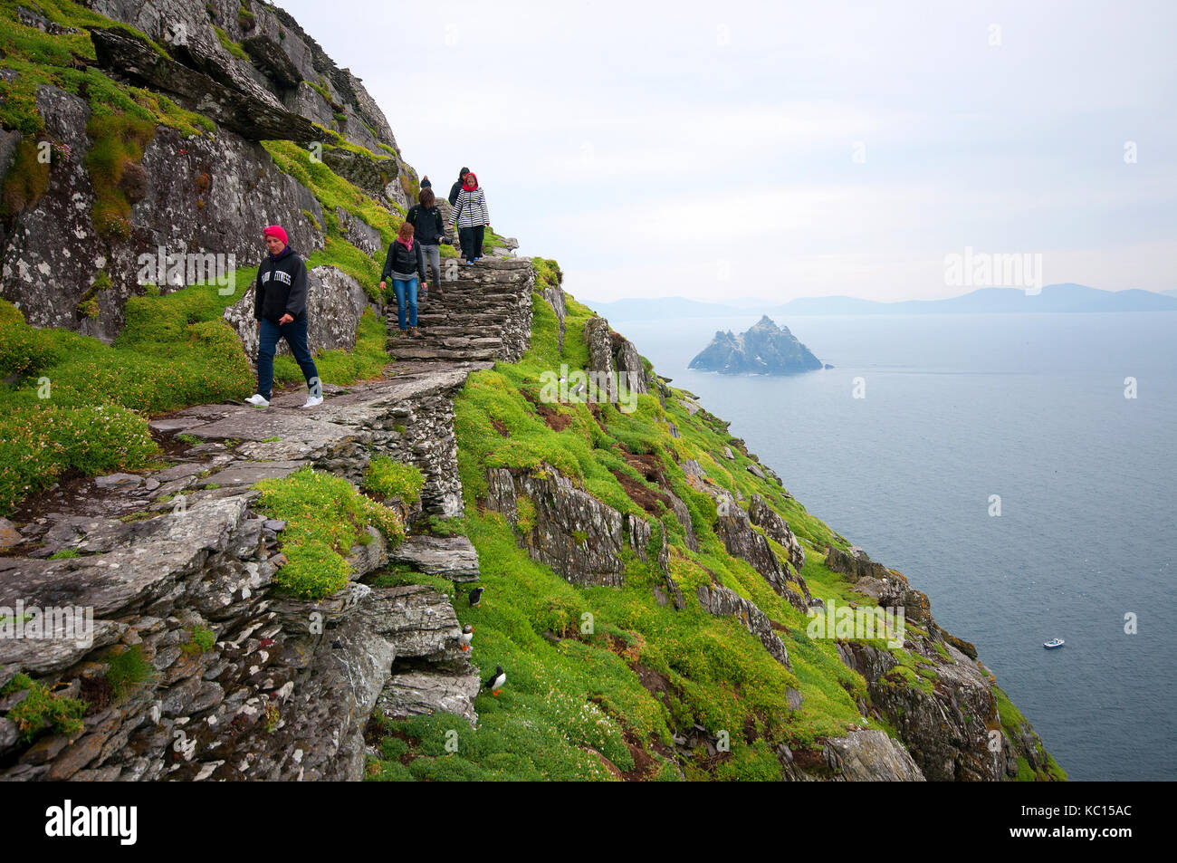 People hiking in Skellig Michael Island (in the backgroun Little ...