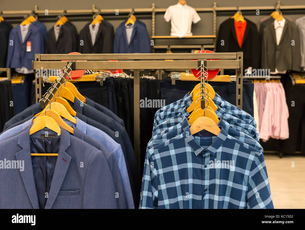 Variety of male clothes hanging on rack in boutique, fashion and ...