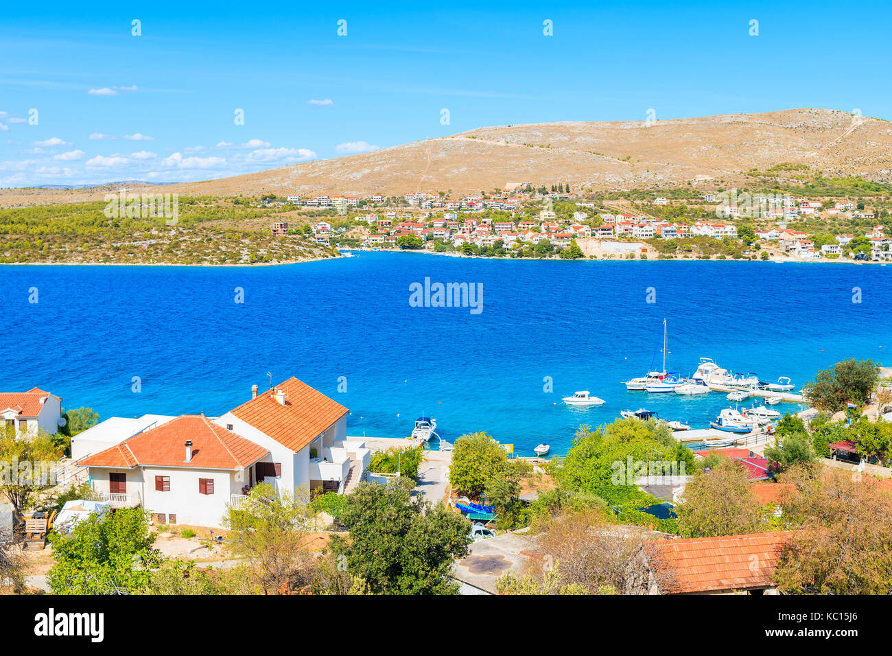 View of houses with orange tile roofs and sea bay near Zaboric town ...
