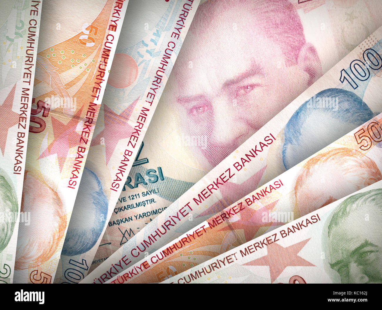 Different money bills stacked over each other forming a money ...