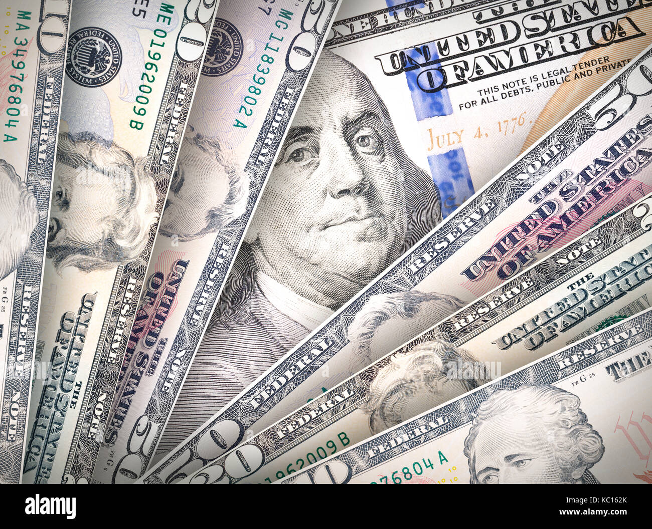 Different money bills stacked over each other forming a money ...