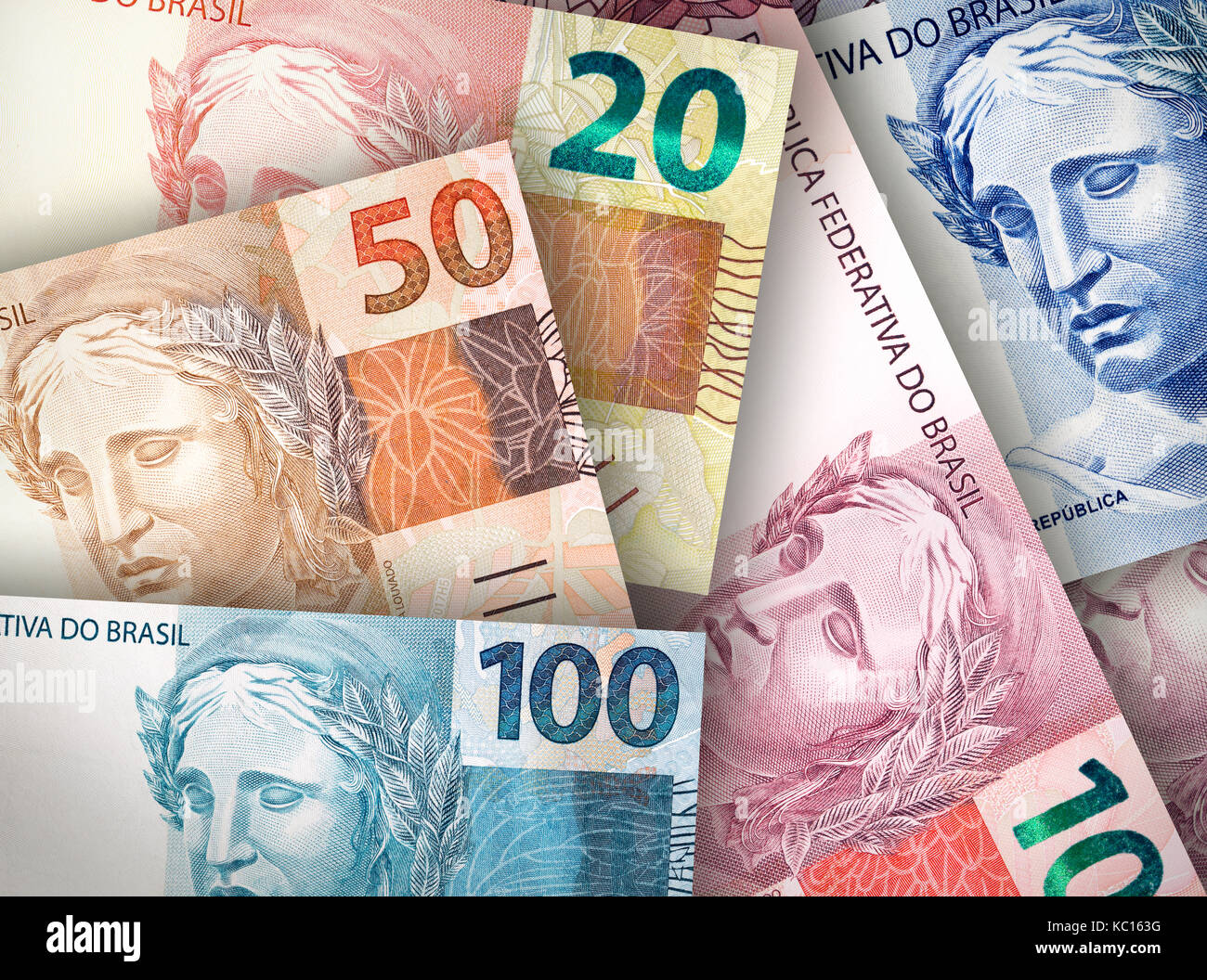Different money bills stacked over each other forming a money ...