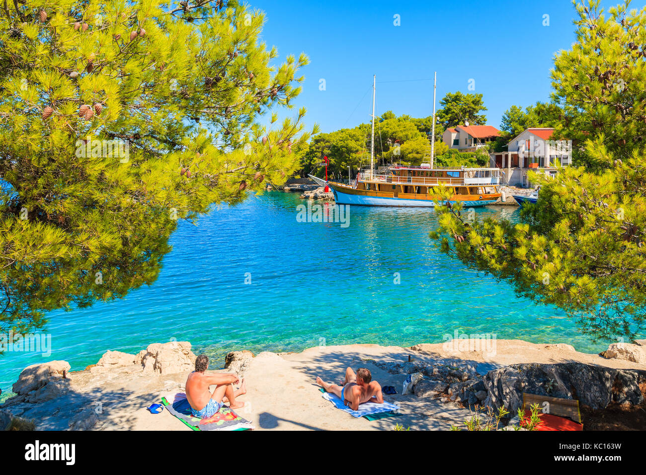 RAZANJ VILLAGE, CROATIA - SEP 6, 2017: Two men sunbathing in beautiful ...