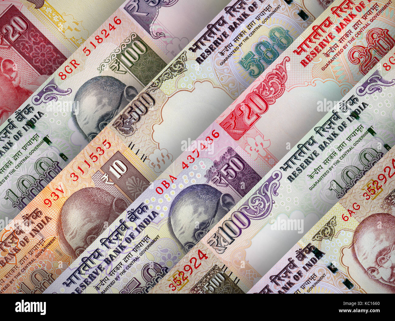 Different money bills stacked over each other forming a money ...