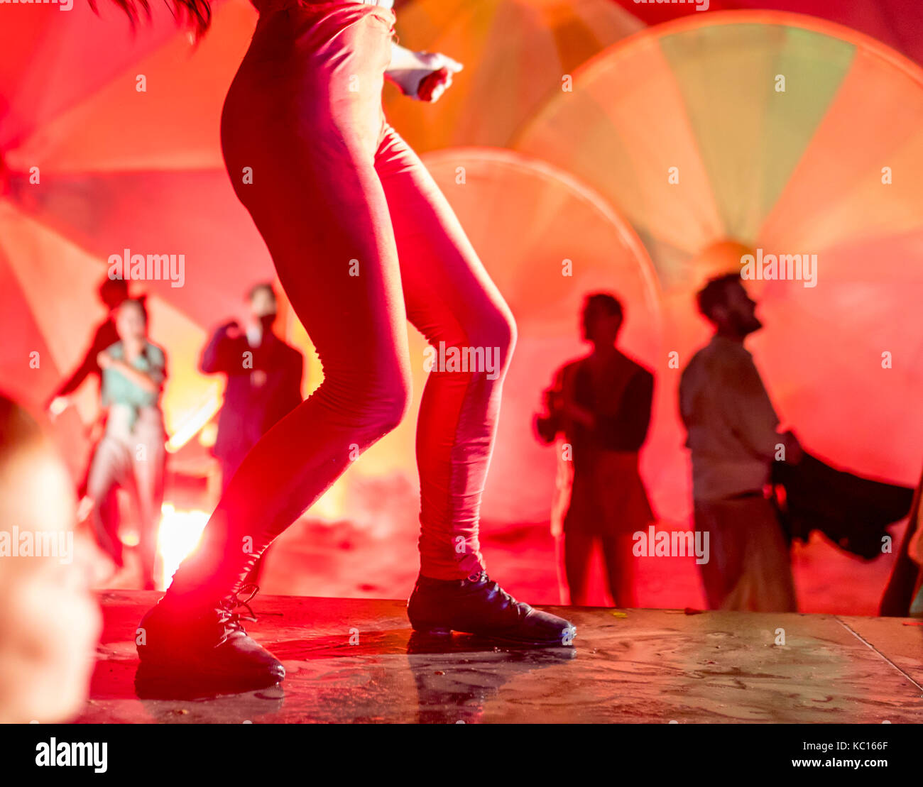 Street festival performer dancing in front of a crowd of people with ...