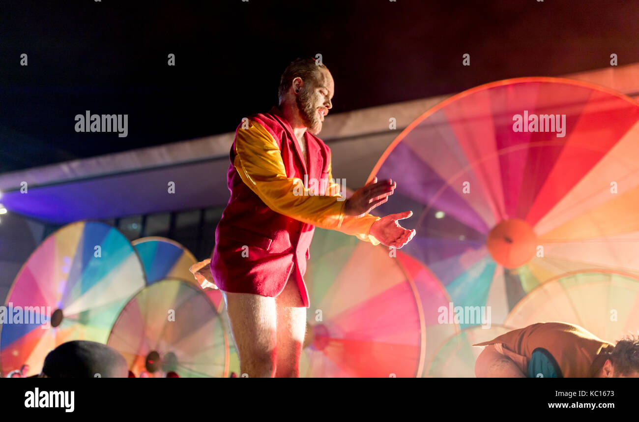 Street festival performer dancing in front of a crowd of people with ...