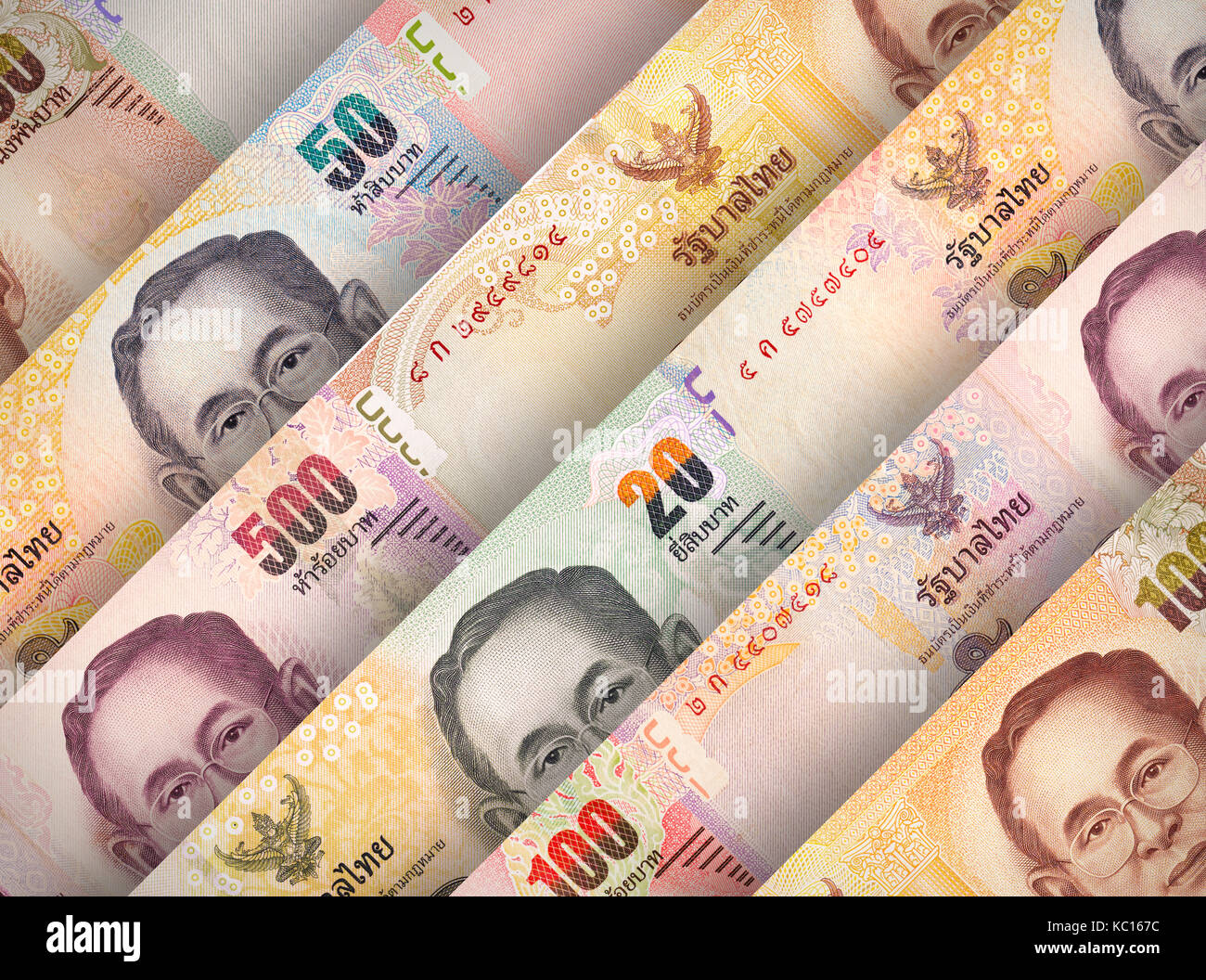 Different money bills stacked over each other forming a money ...