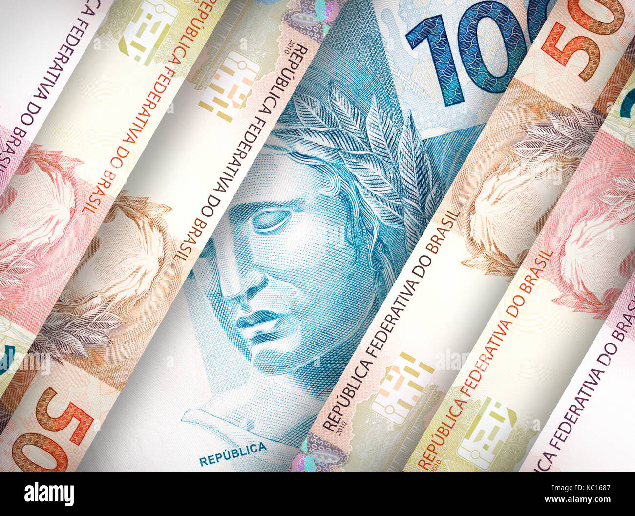 Different money bills stacked over each other forming a money ...