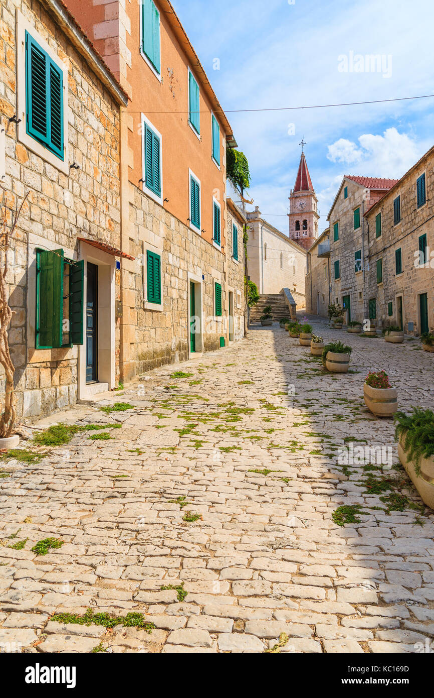 Street with typical stone houses in Postira old town, Brac island ...