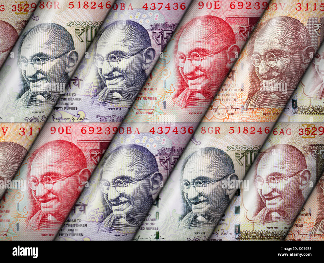 Different money bills stacked over each other forming a money ...