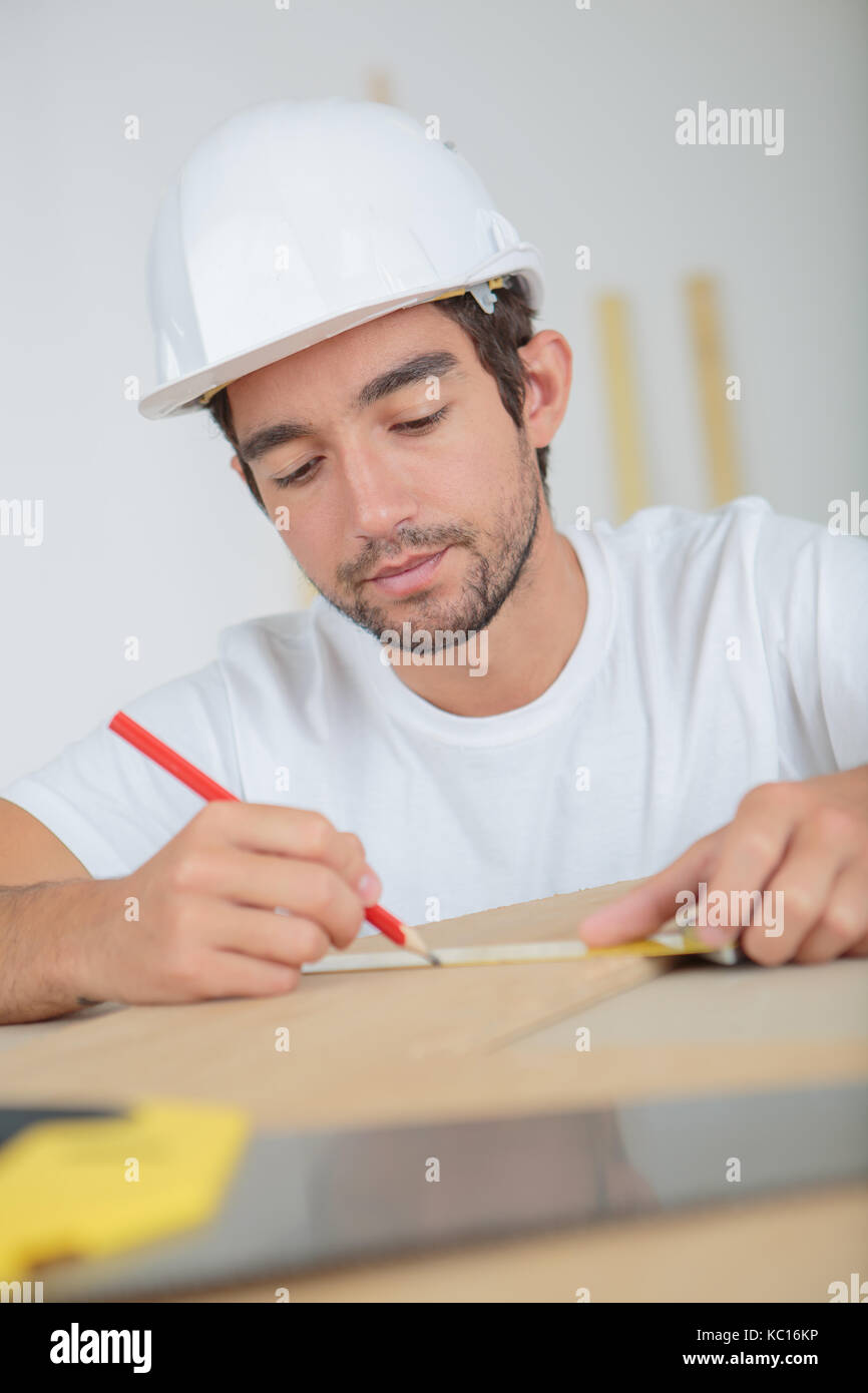man measuring a plank Stock Photo - Alamy