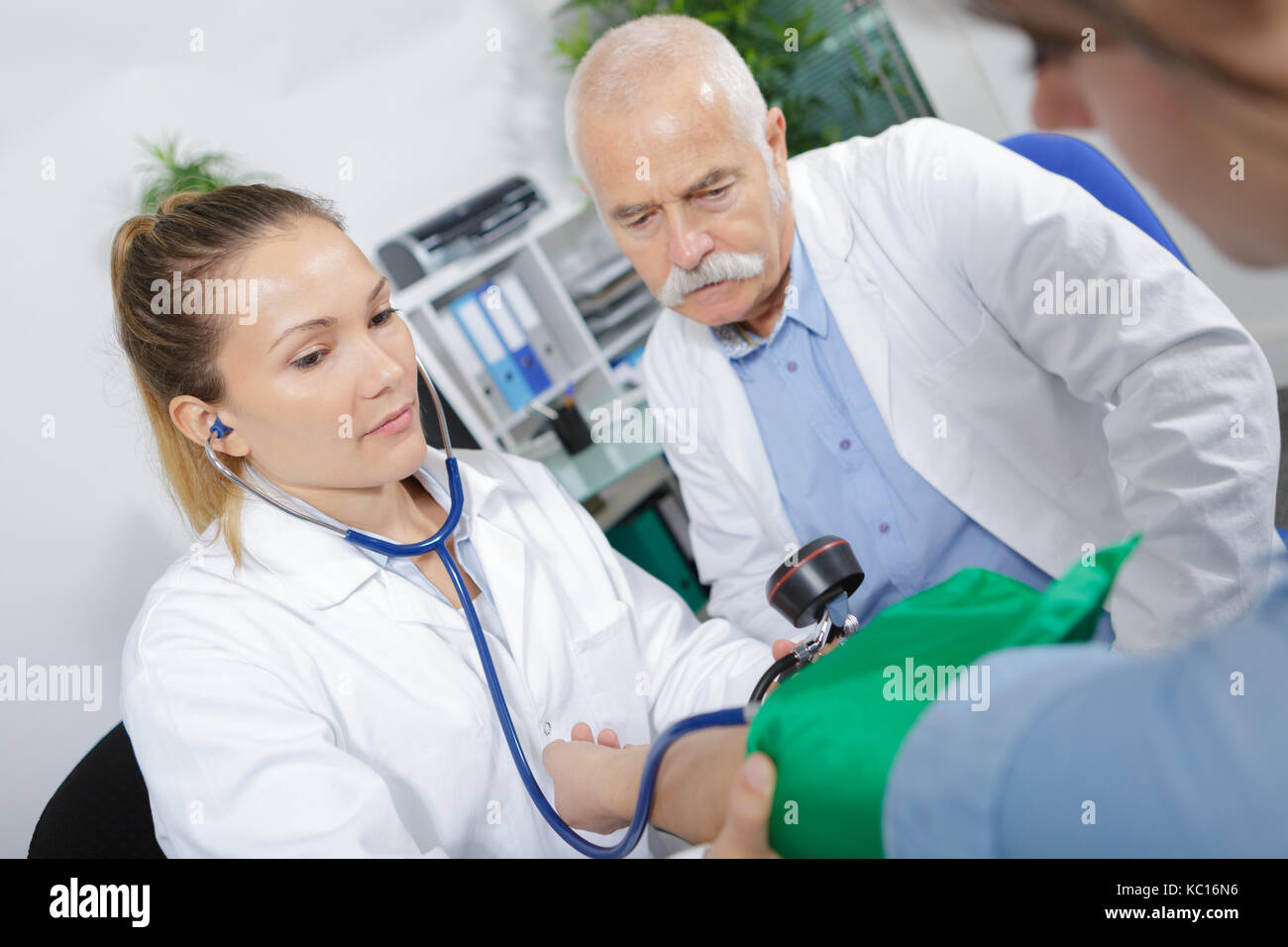 doctors checking patient Stock Photo - Alamy