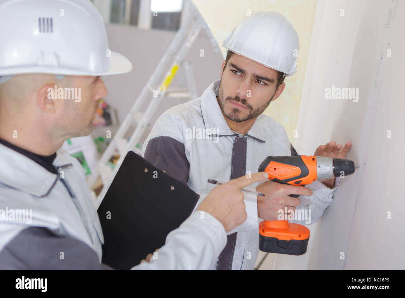 worker using an electric drill Stock Photo - Alamy