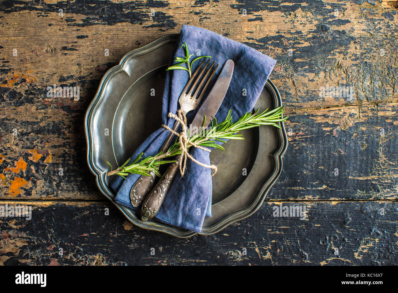 Rustic table setting with empty plate and vintage silverware decorated ...