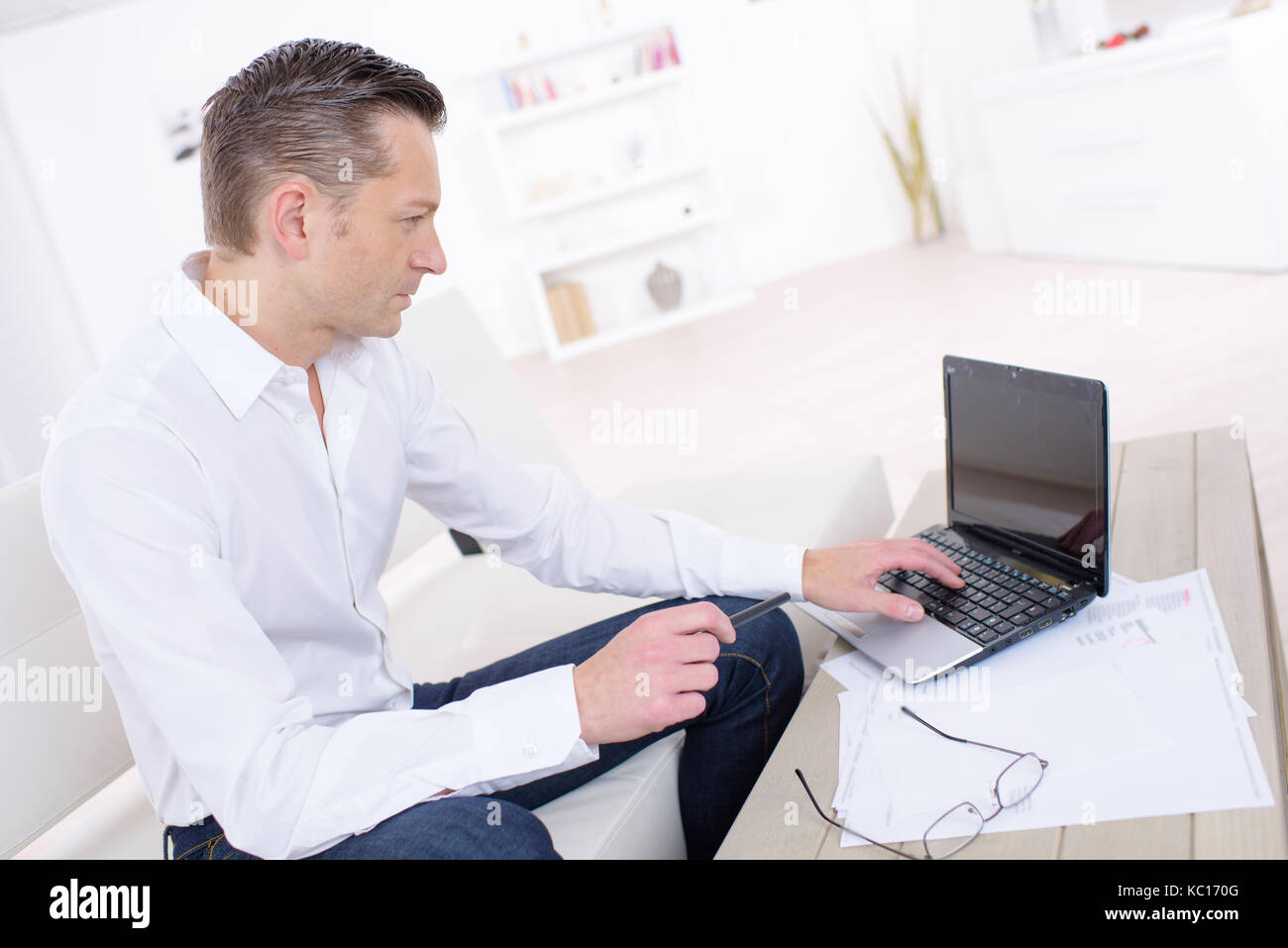man operating the laptop Stock Photo - Alamy