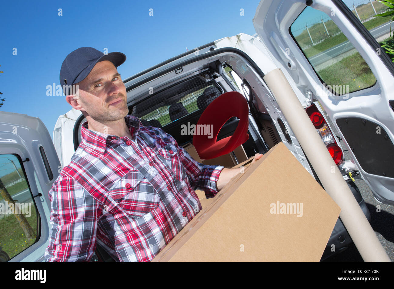 delivery man checking packages Stock Photo - Alamy