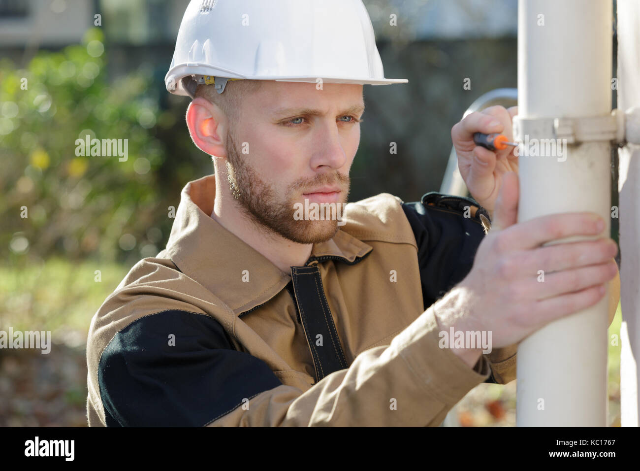 builder fixing drain pipes Stock Photo - Alamy