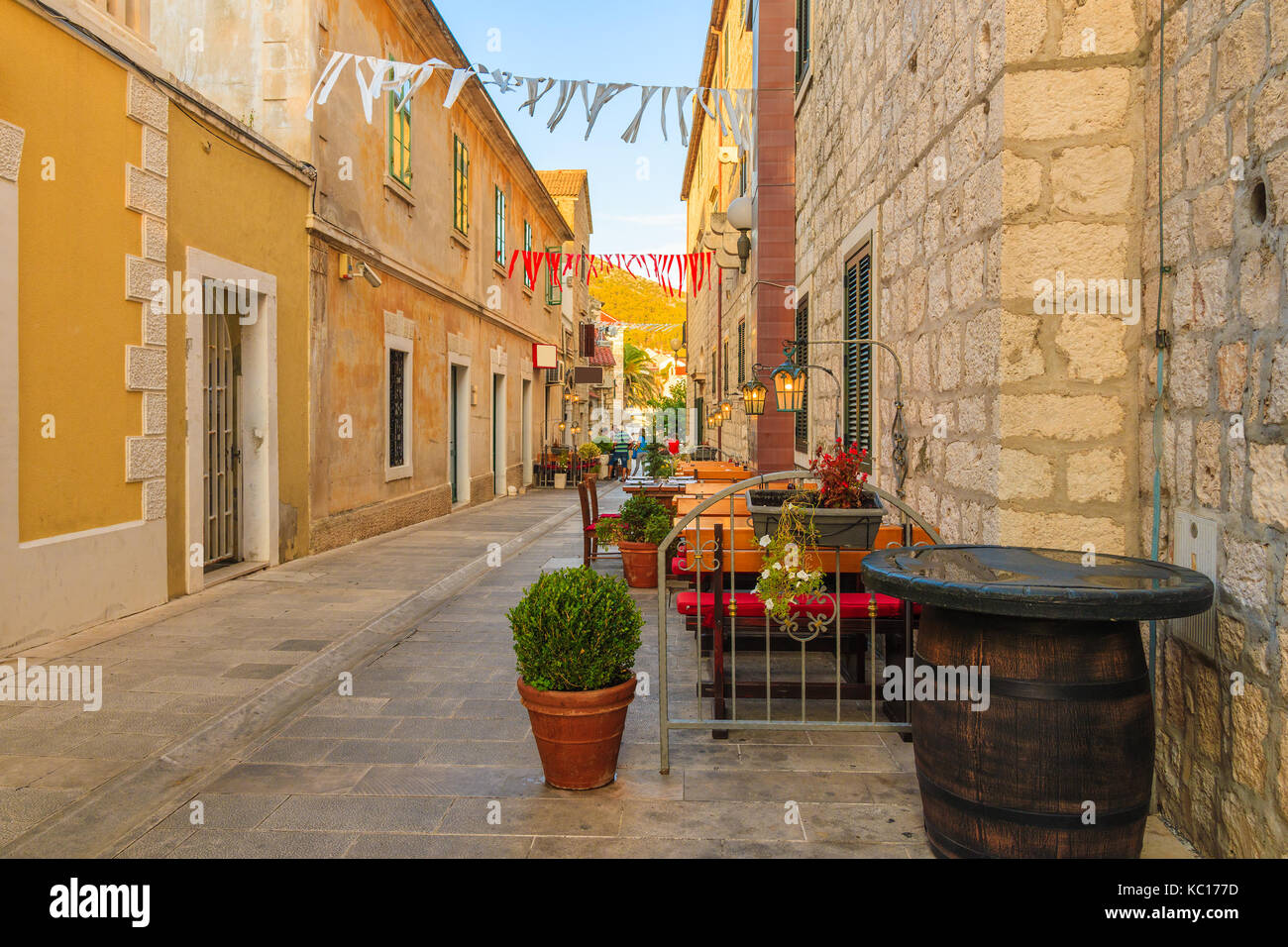 Restaurant tables on street of Bol port old town, Brac island, Croatia ...