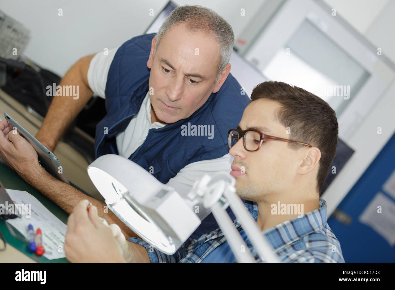 jeweler looking at diamond through loupe to inspect it Stock Photo - Alamy