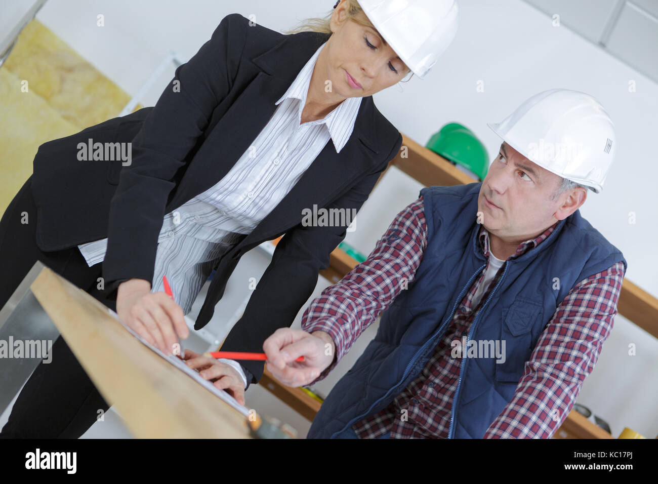female engineer talking with builder Stock Photo - Alamy