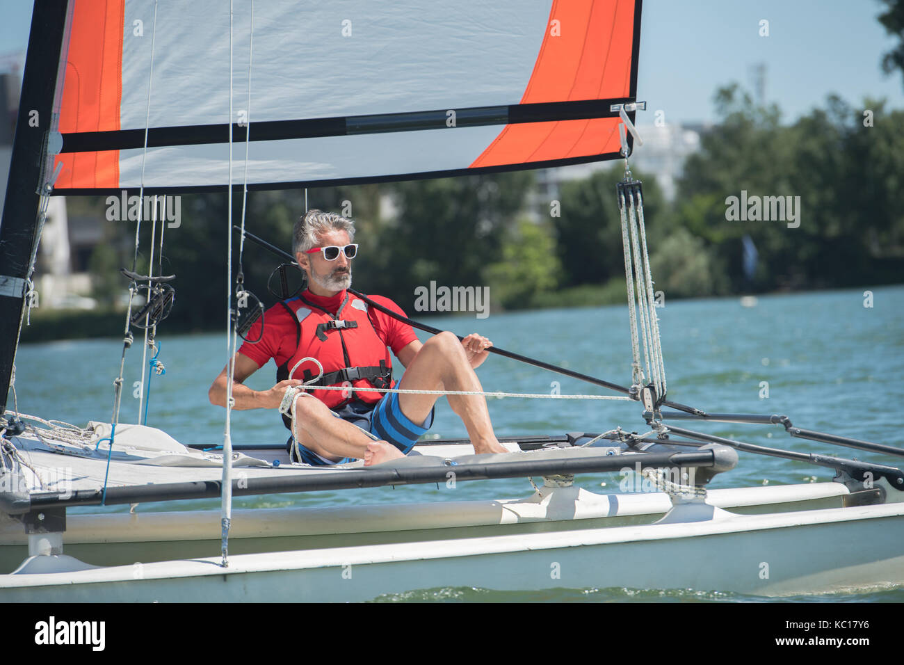 sailing man on boat Stock Photo - Alamy