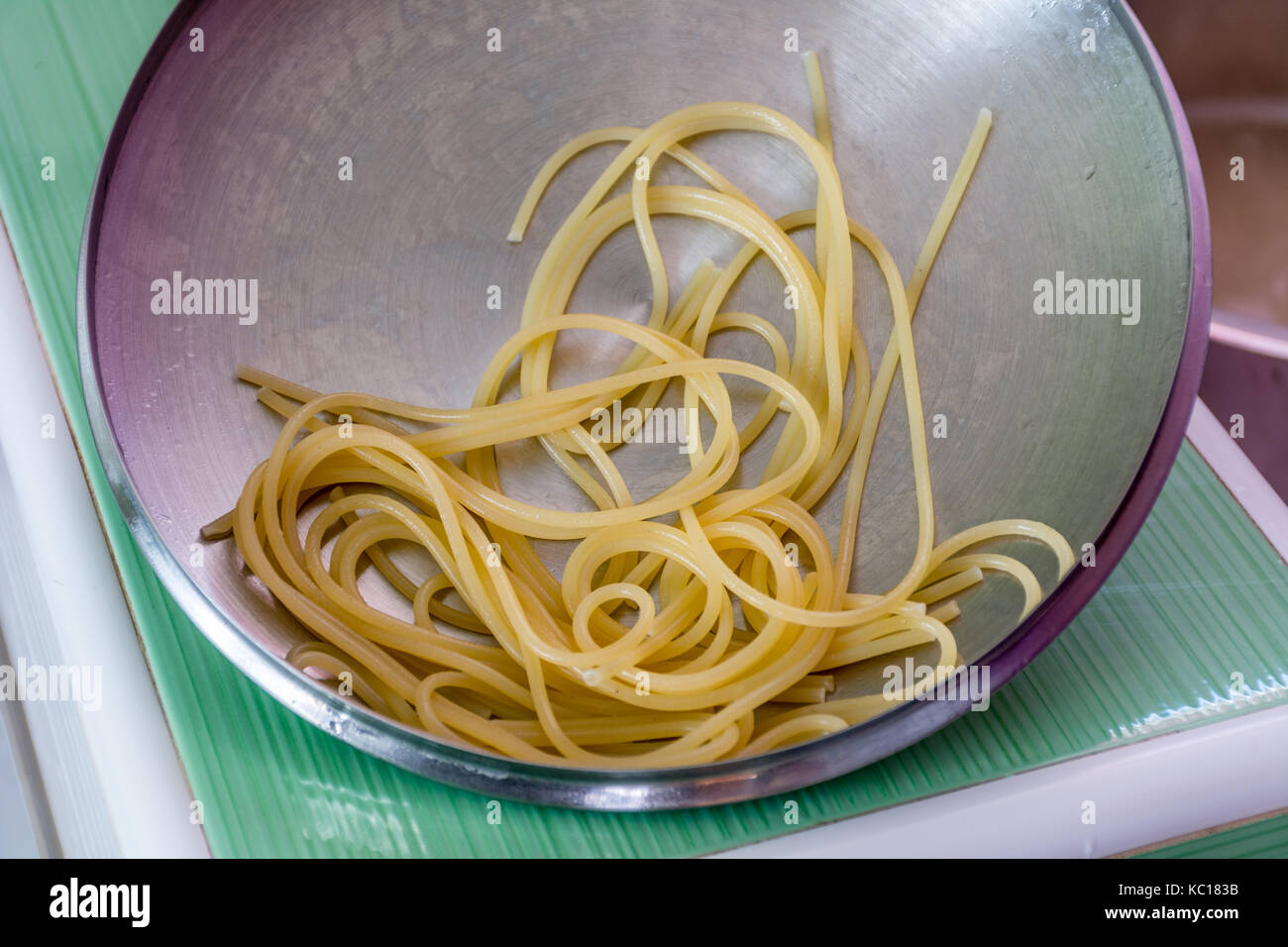 Half cooked spaghetti in the cover of steel pan Stock Photo - Alamy