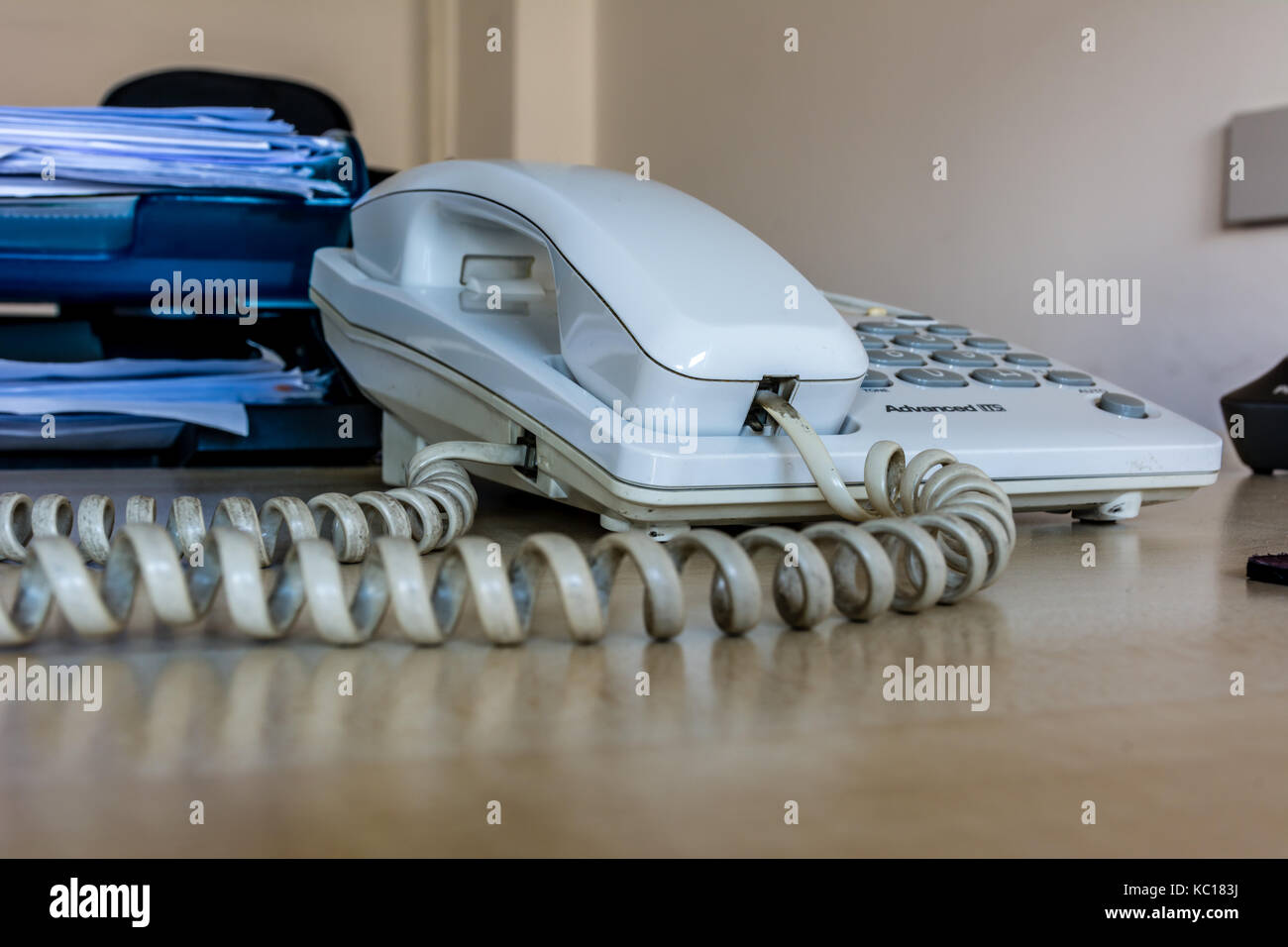 Old white office desktop phone with cord and traces of use Stock Photo ...