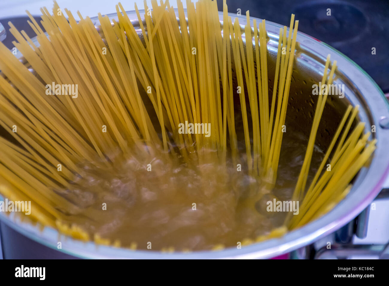 Spaghetti in boiled water in the steel pan Stock Photo - Alamy