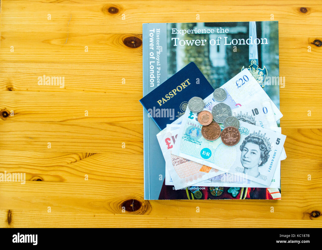 Tower of London guidebook with British money and American passport on a ...