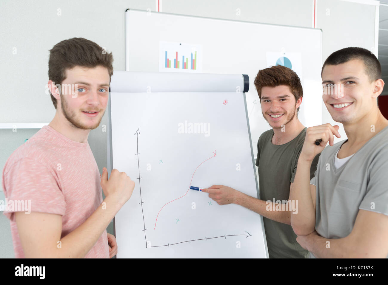 three teenage boys presenting a project Stock Photo - Alamy
