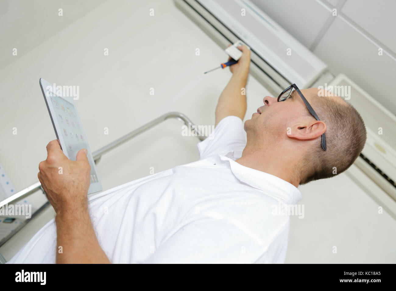 engineer reading technical information on tablet computer Stock Photo ...