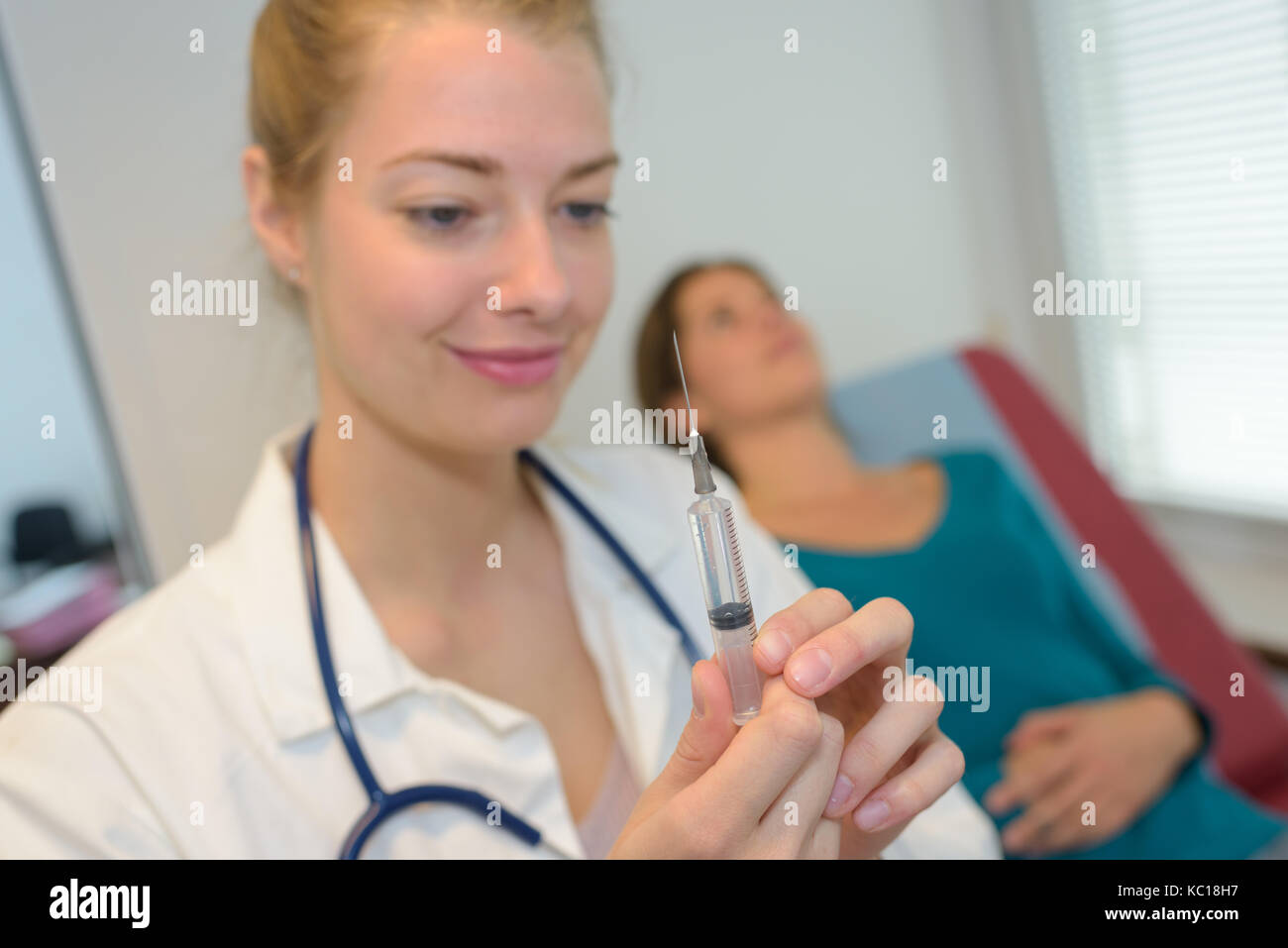 beautiful nurse is holding injection Stock Photo - Alamy