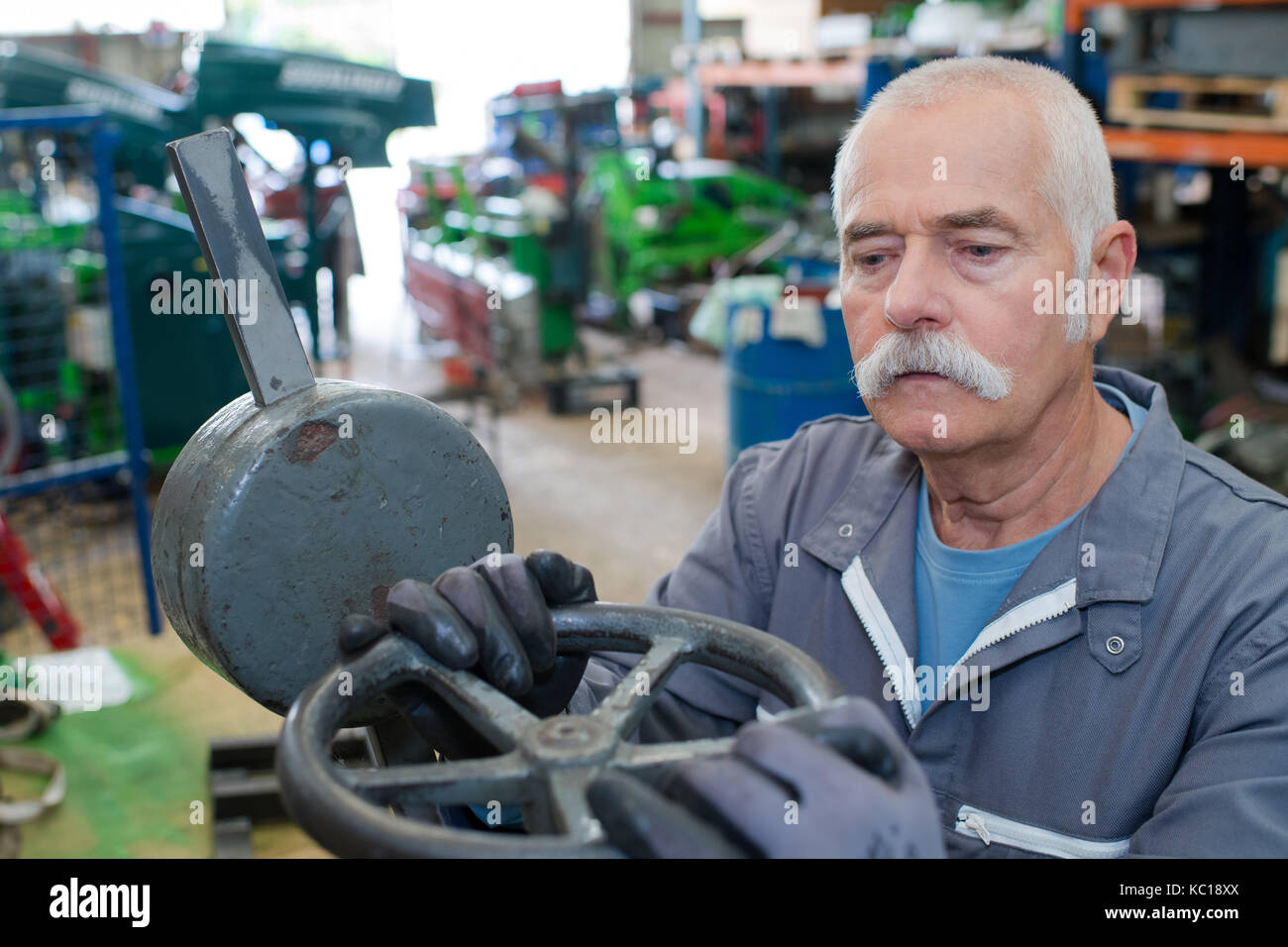 senior mechanic works at a factory Stock Photo - Alamy