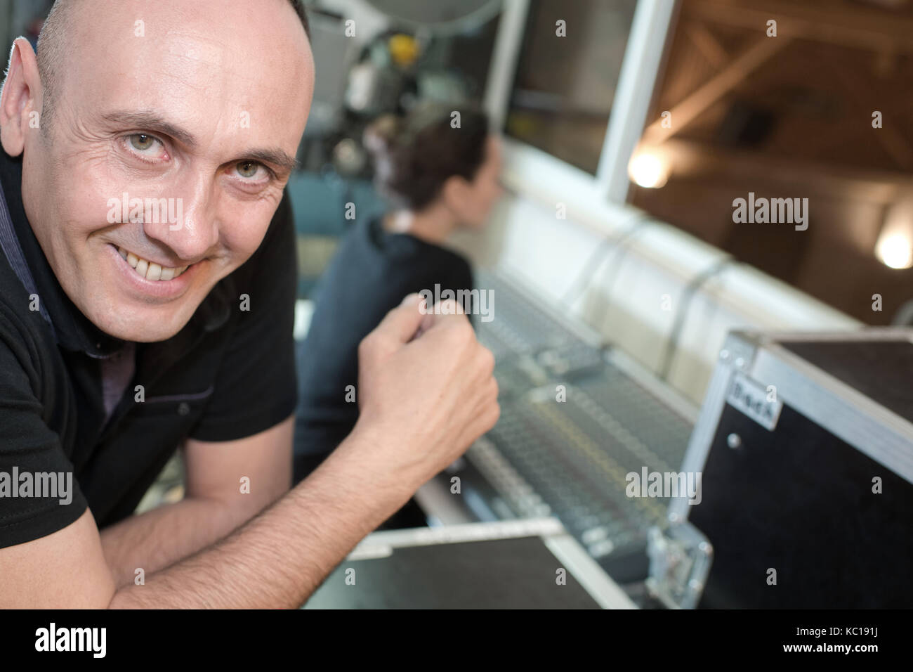 engineer sitting at mixing desk in recording studio Stock Photo - Alamy