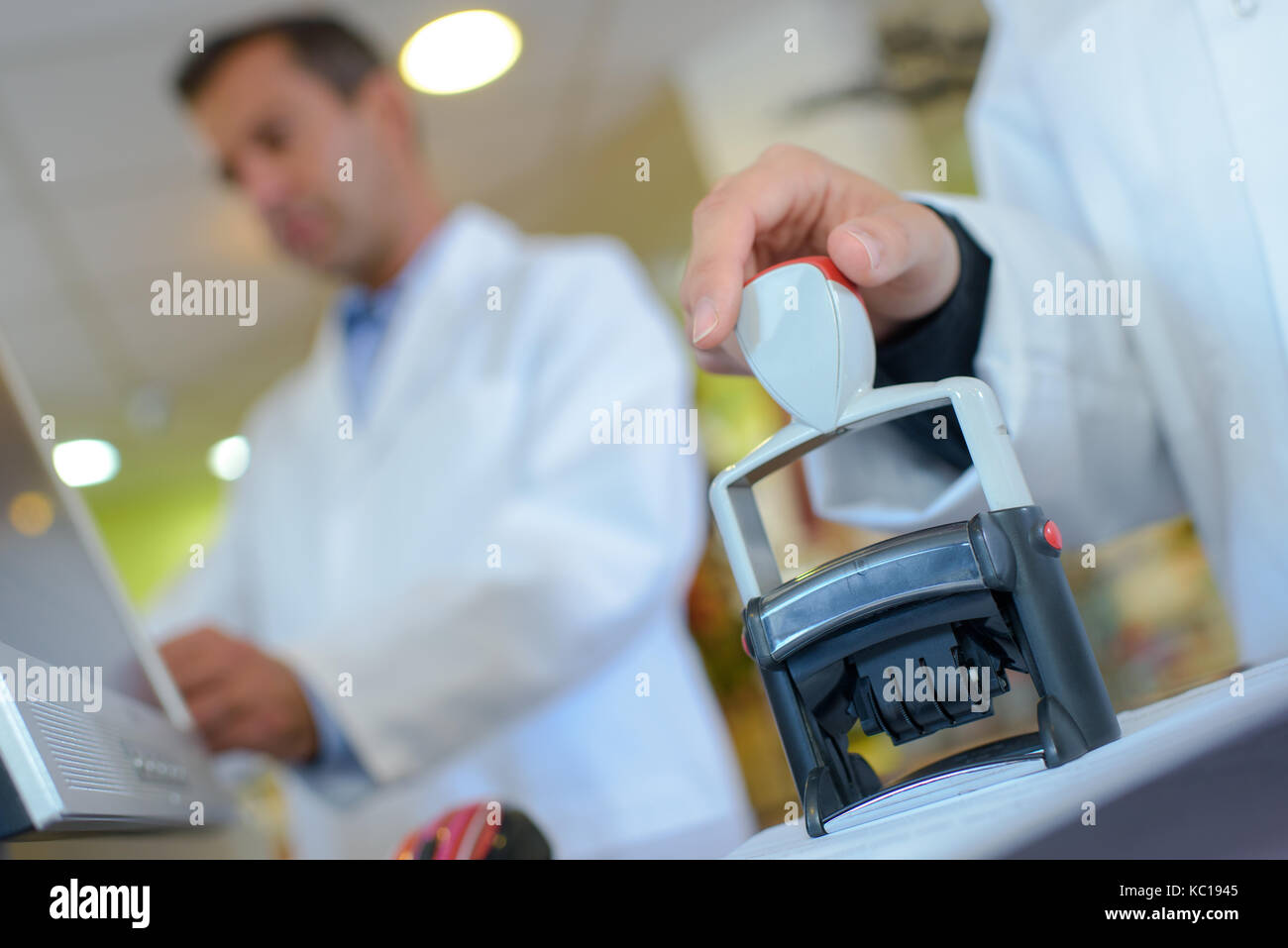 hospital worker stamping document Stock Photo - Alamy