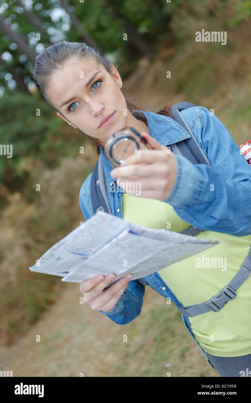 young woman searching direction with a compass Stock Photo - Alamy