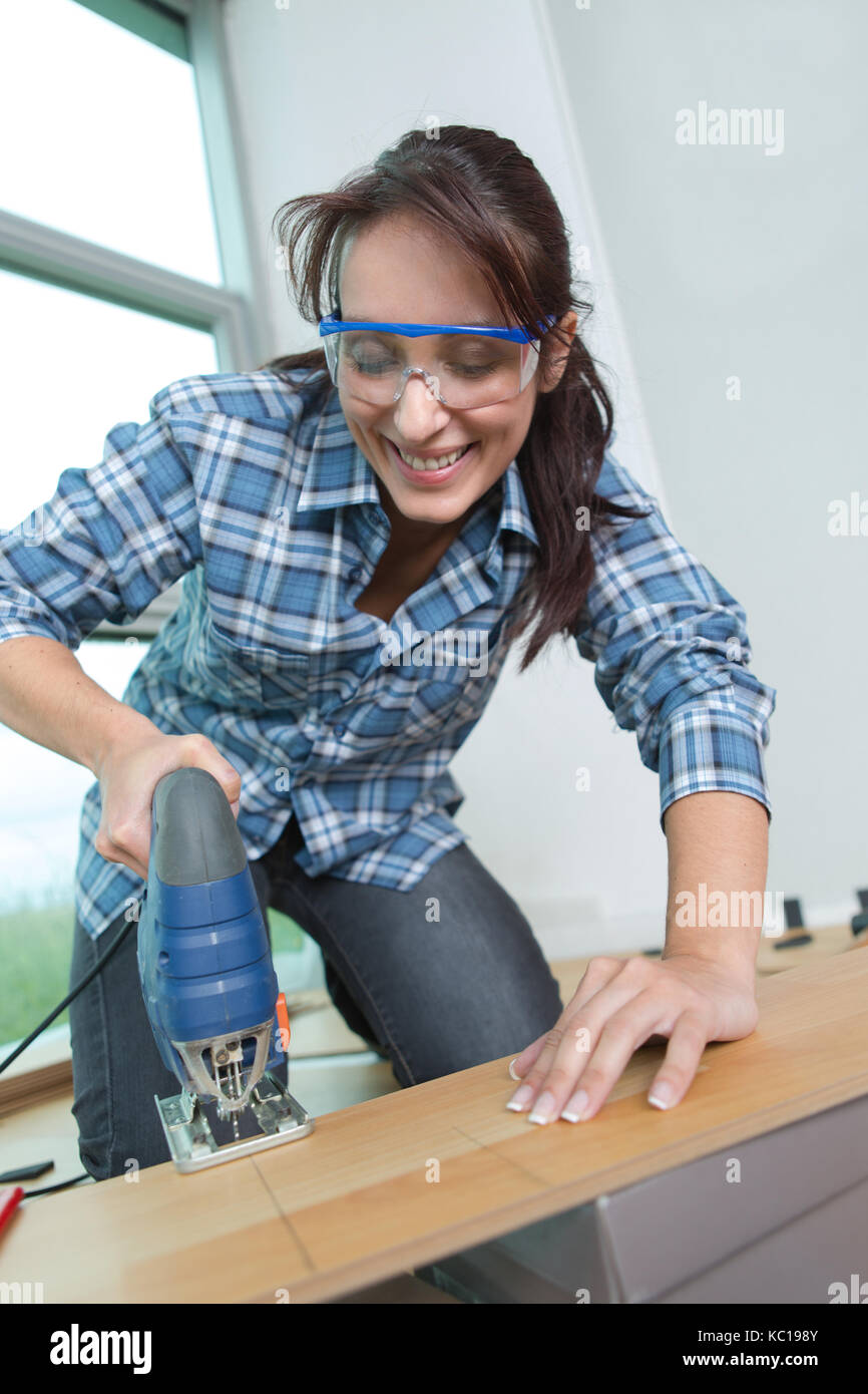 female cutting wood wearing eye protection Stock Photo - Alamy