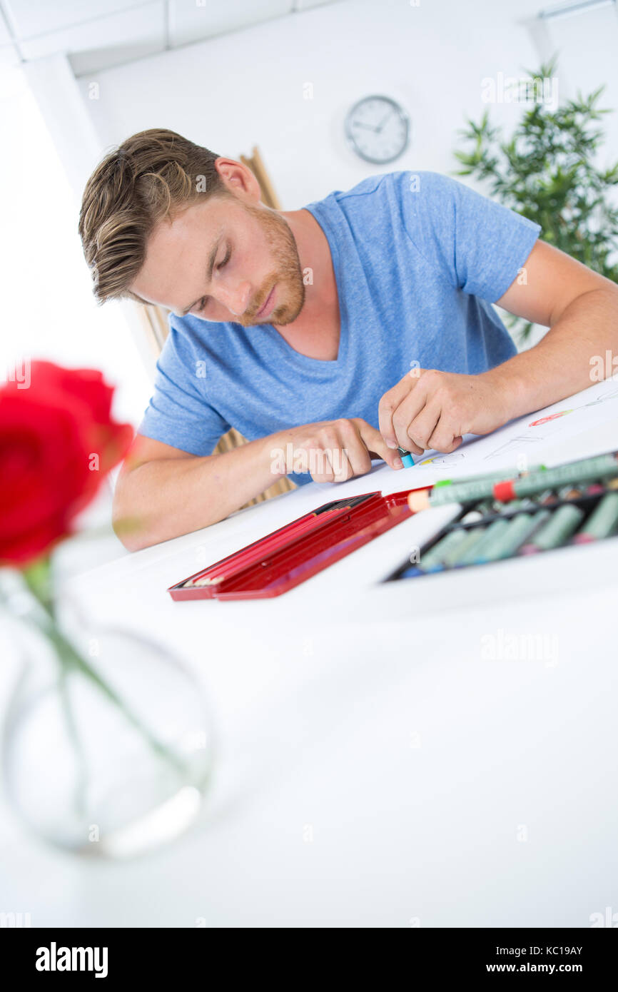 man drawing in drawing book at home Stock Photo - Alamy