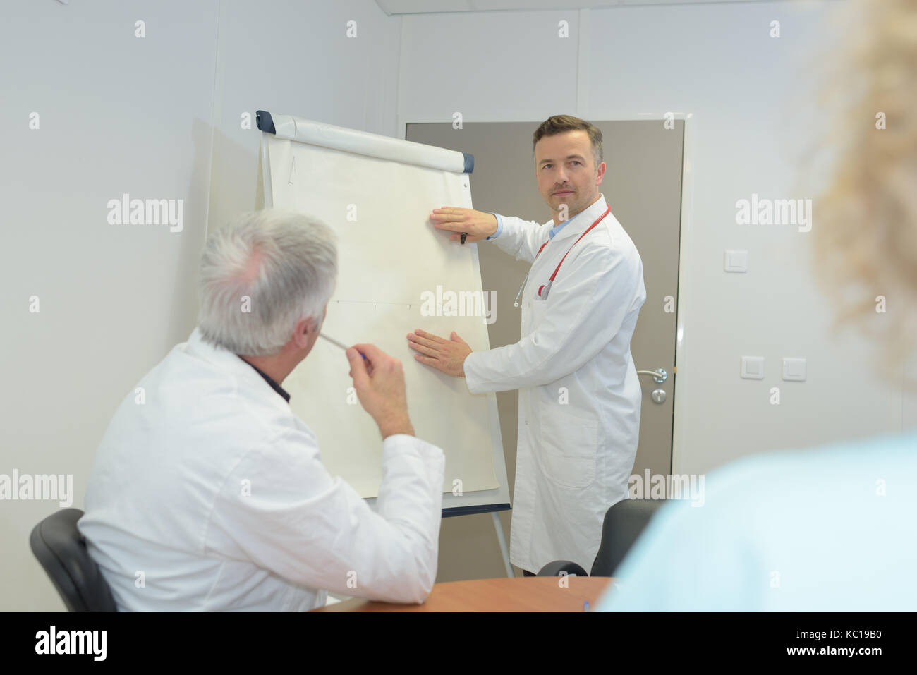 doctors looking at white board in meeting Stock Photo - Alamy