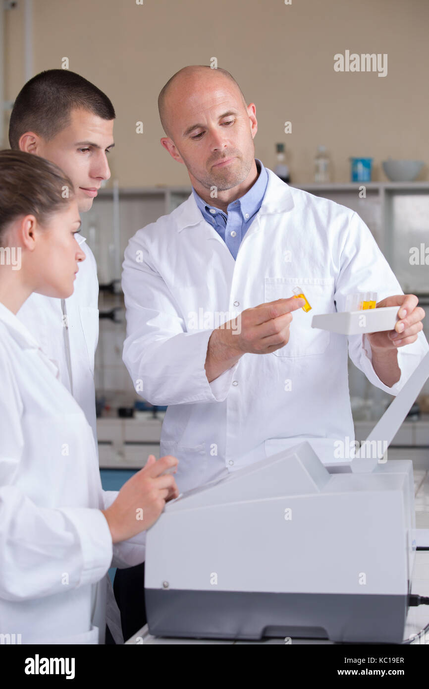 teacher in chemistry lab showing samples to his students Stock Photo ...