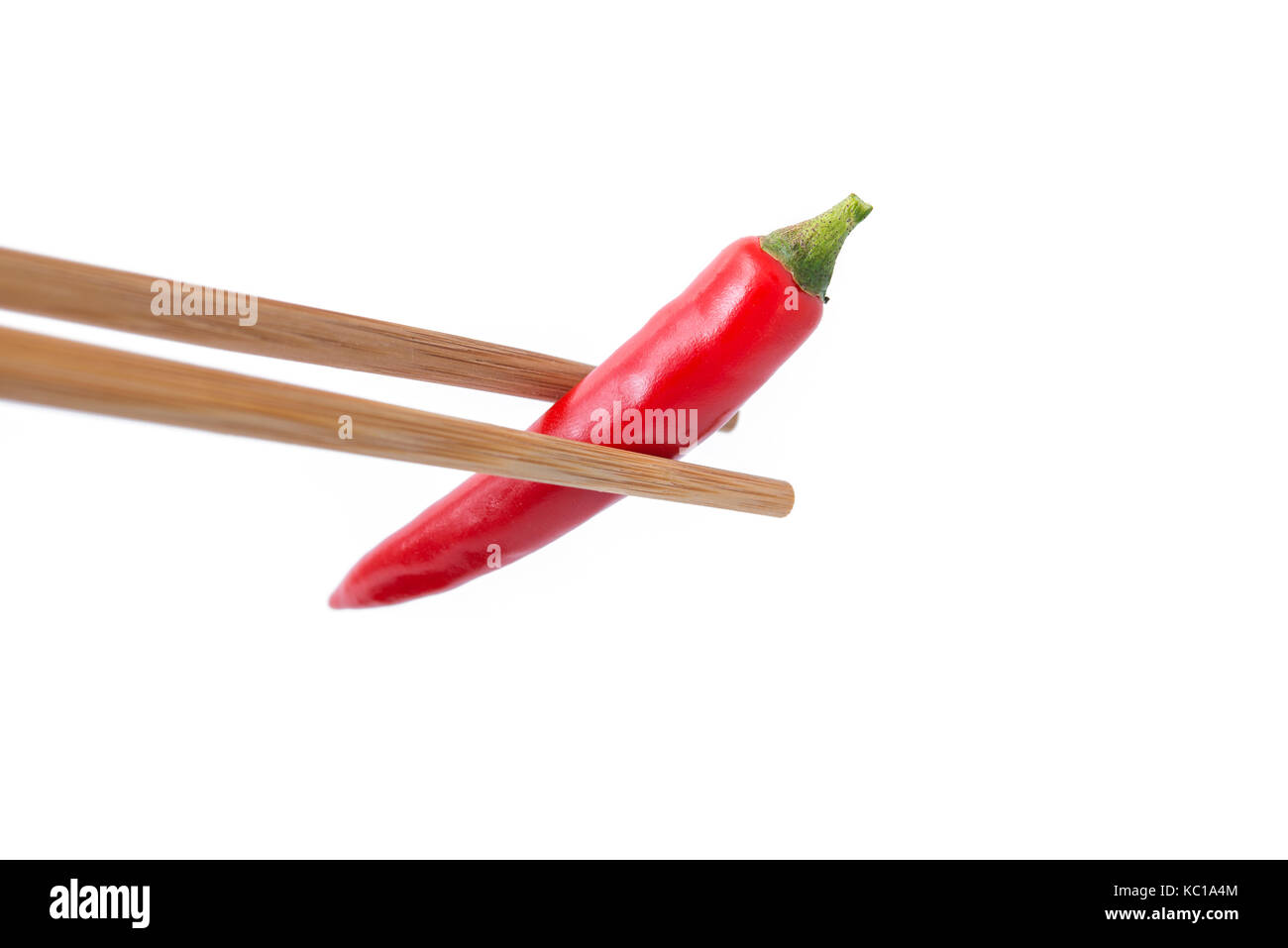eating red hot pepper with chopsticks isolated on white background ...