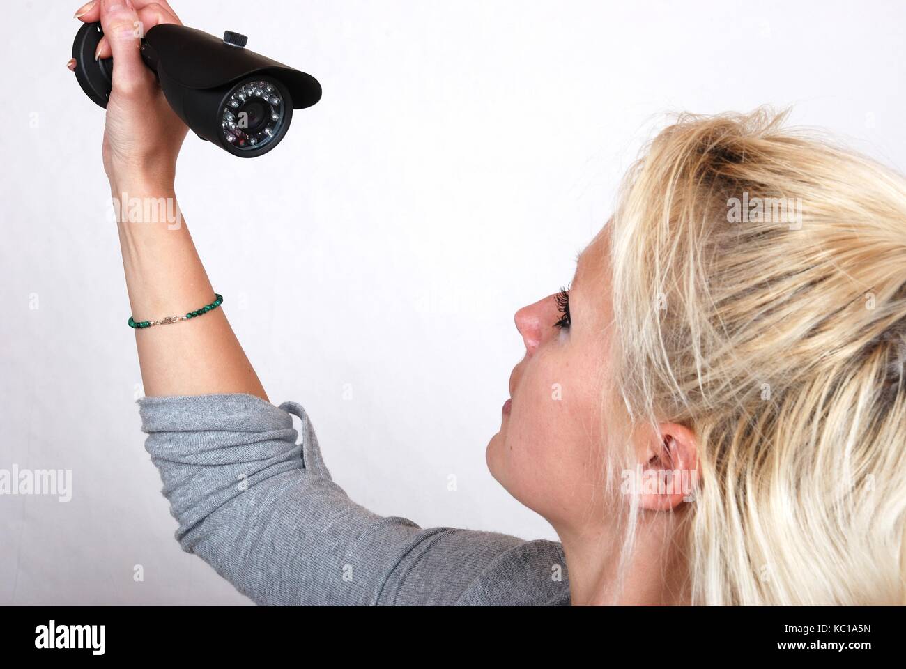 woman making face at security camera Stock Photo - Alamy